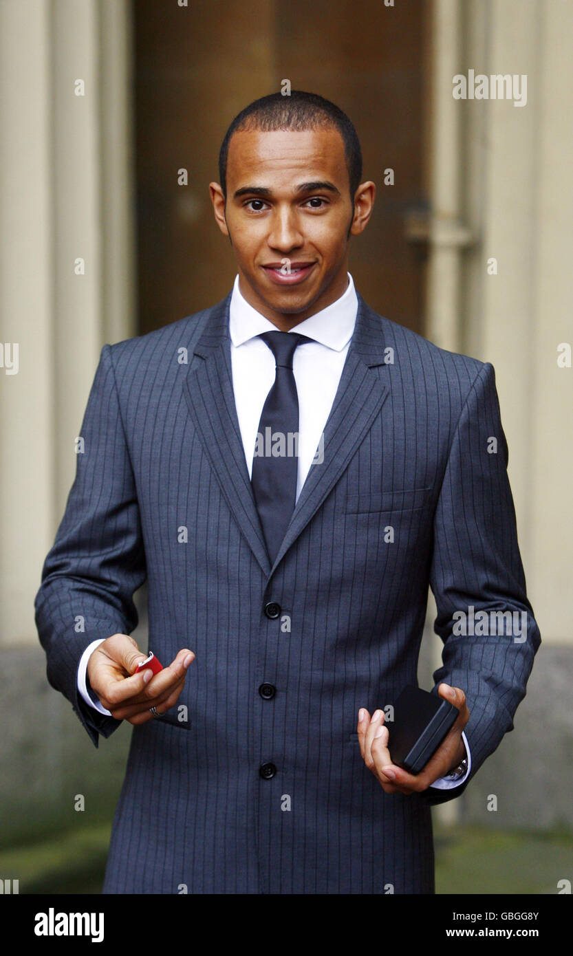 Formula One world champion Lewis Hamilton with the MBE he received from ...