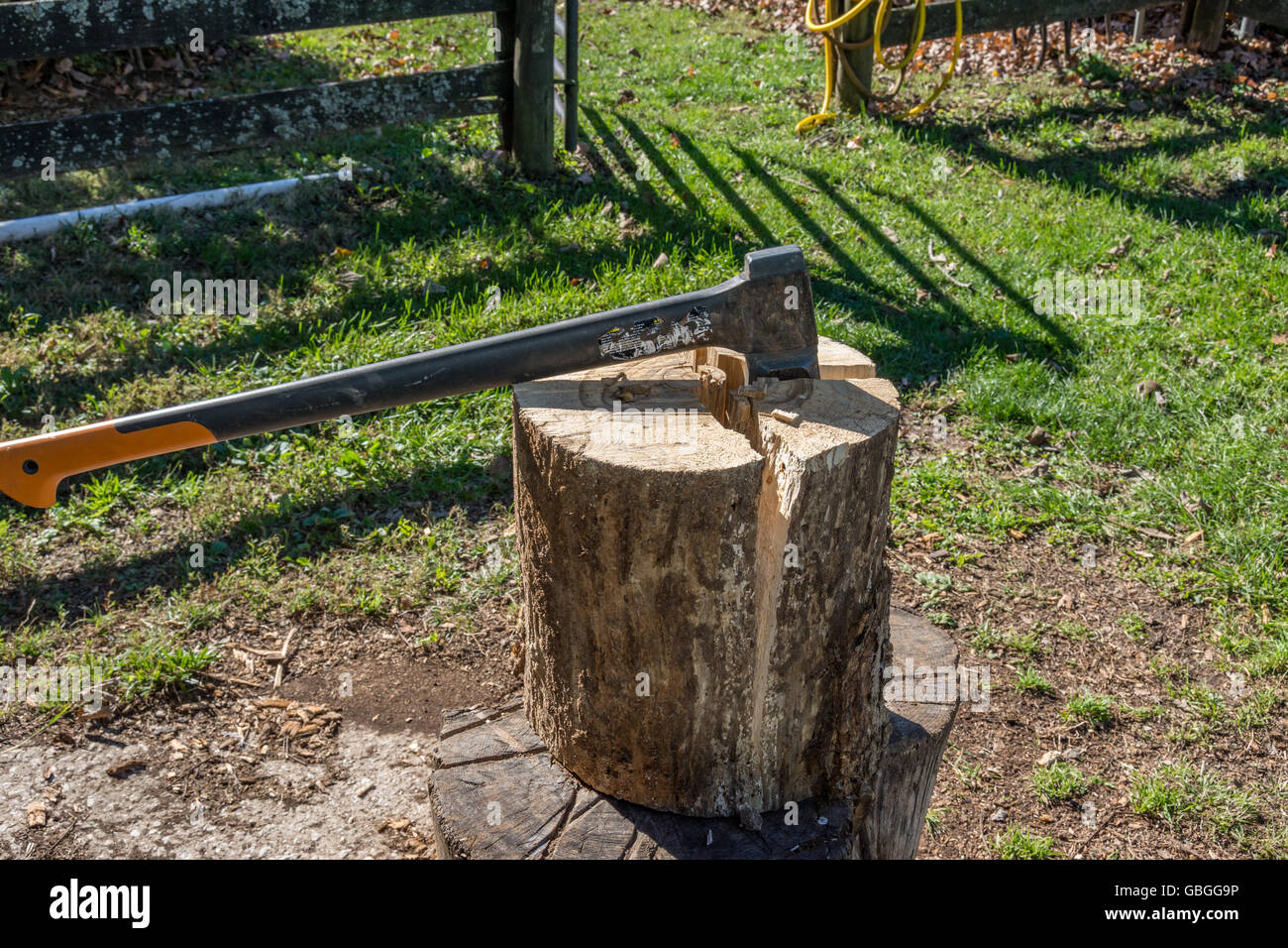 Wood being split with a splitting maul for firewood Stock Photo - Alamy
