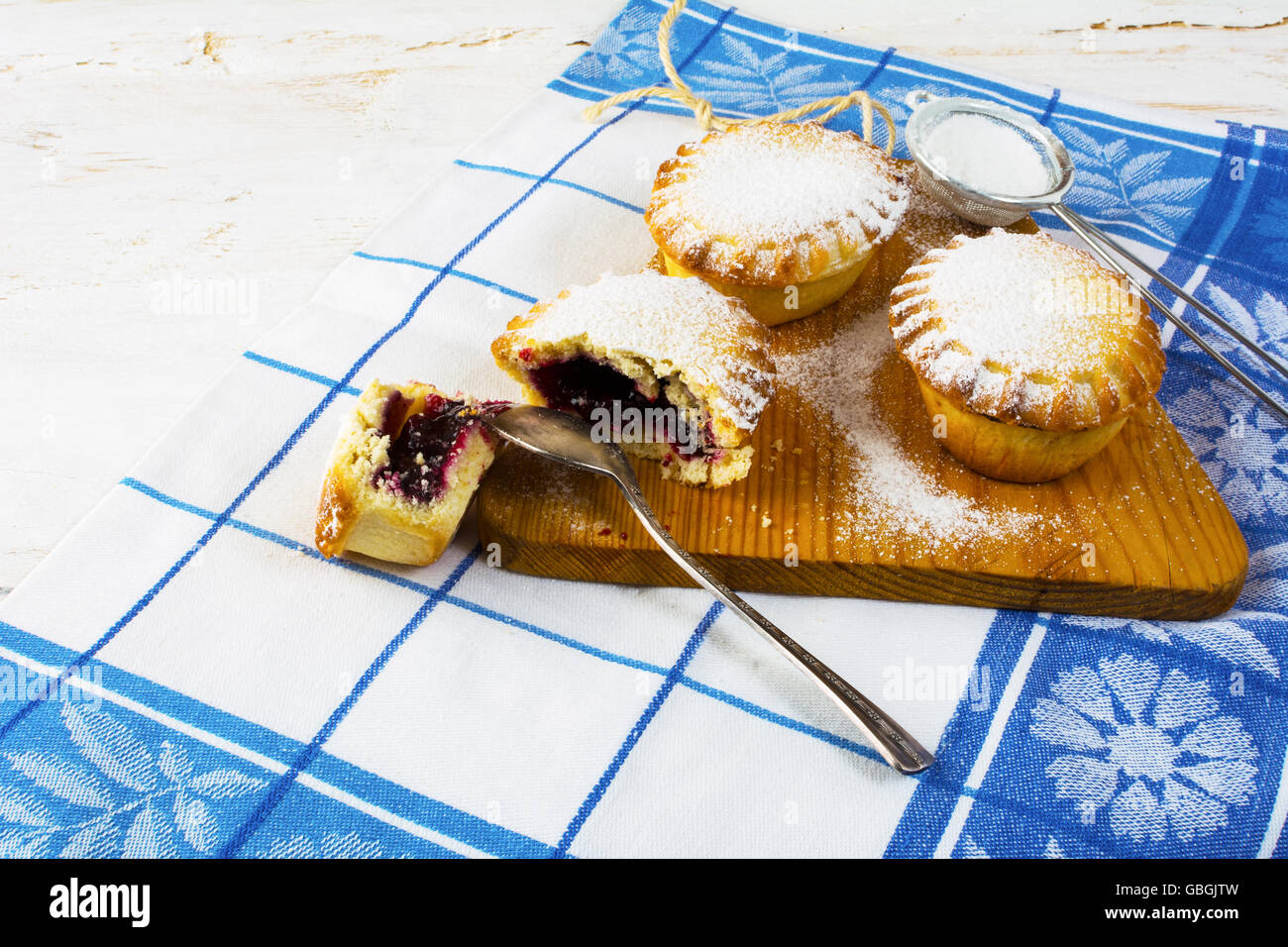 Small sweet pie on the cutting board. Sweet dessert. Sweet pastry. Jam ...