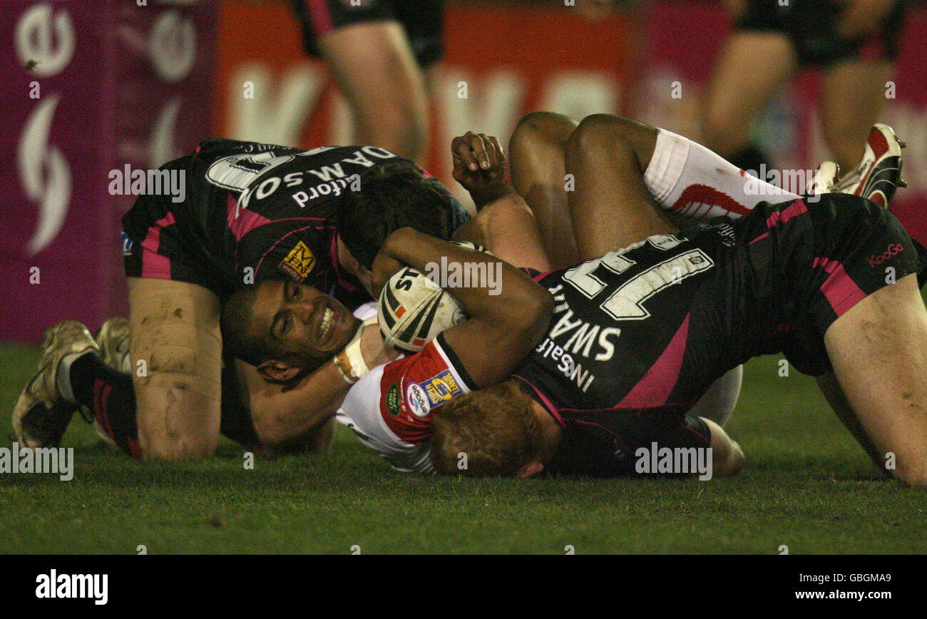 St Helens' Leon Price is tackled by Salford's Luke Adamson and Luke ...