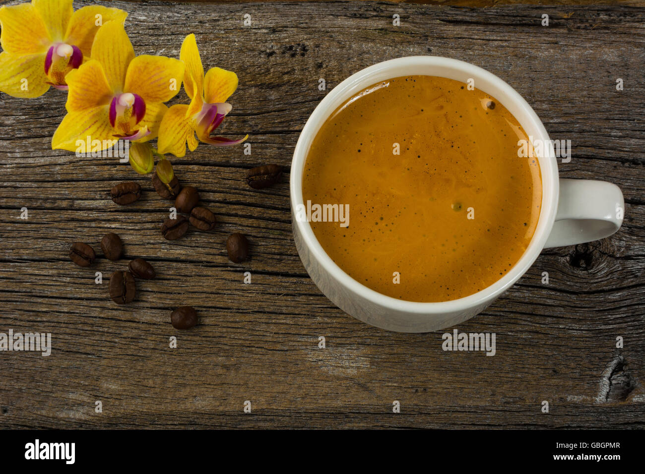 Coffee mug and yellow orchid on the wooden background. Coffee cup. Cup ...
