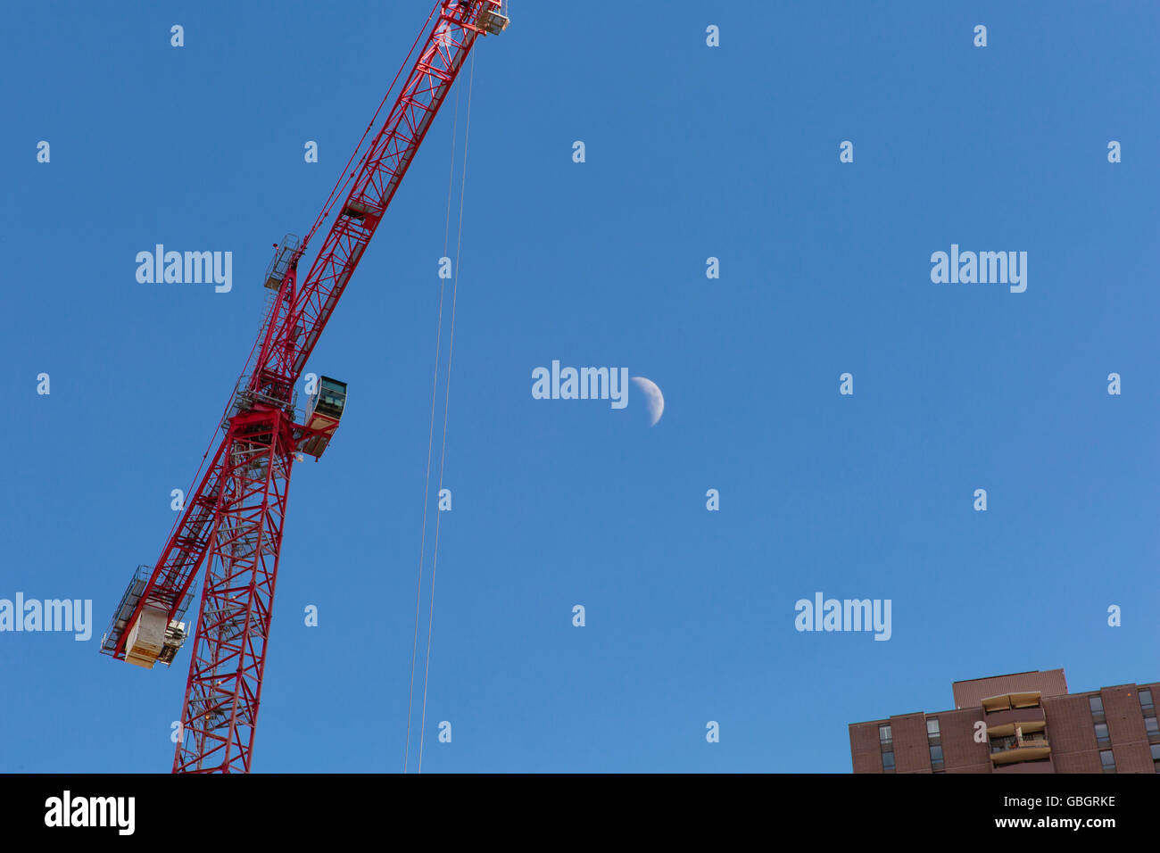 Crescent moon with construction crane Stock Photo - Alamy