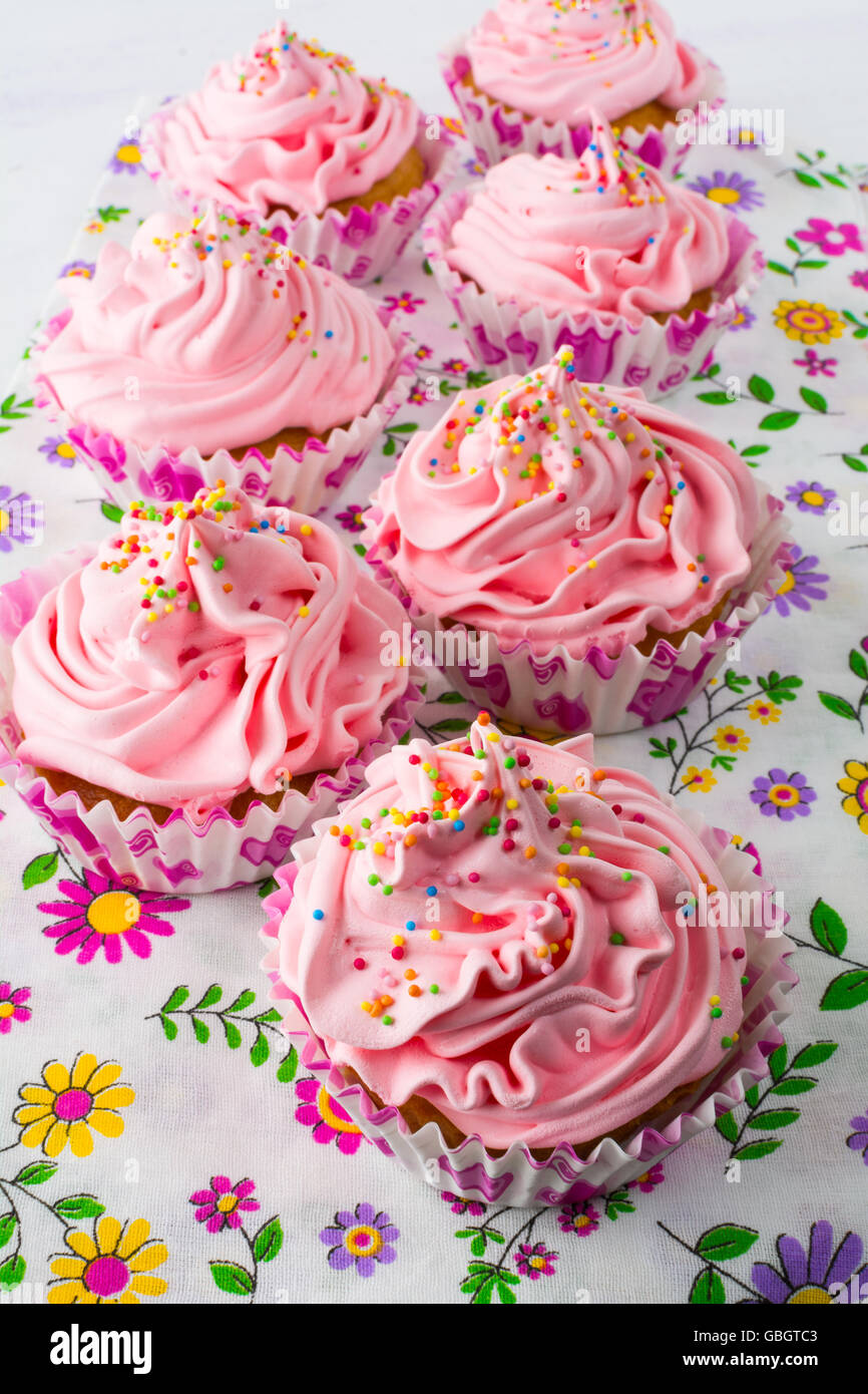 Pink cupcakes on floral pattern napkin. Homemade cupcake. Sweet dessert ...