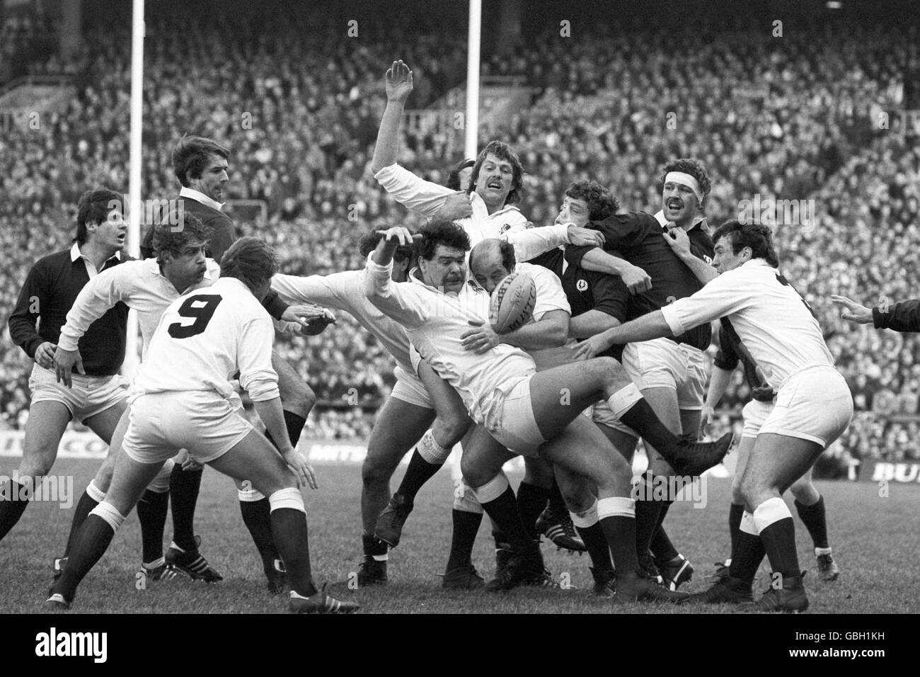 Steve Bainbridge and Colin Smart of England, centre, scramble for a ...