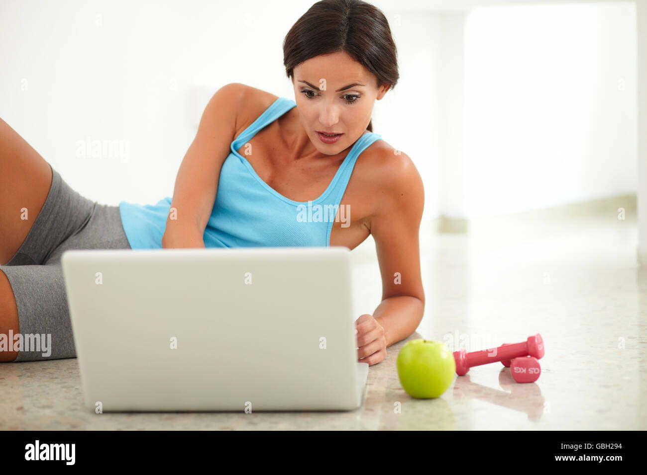 Hispanic fit woman in training clothes browsing the web Stock Photo - Alamy