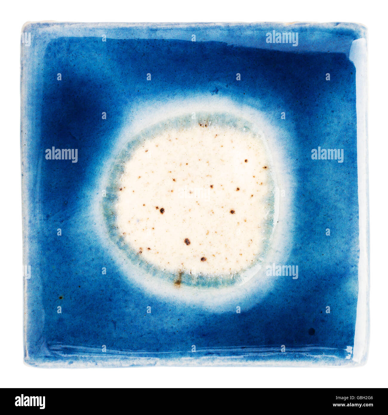 Blue handmade glazed ceramic tile with big dot in middle cutout on ...