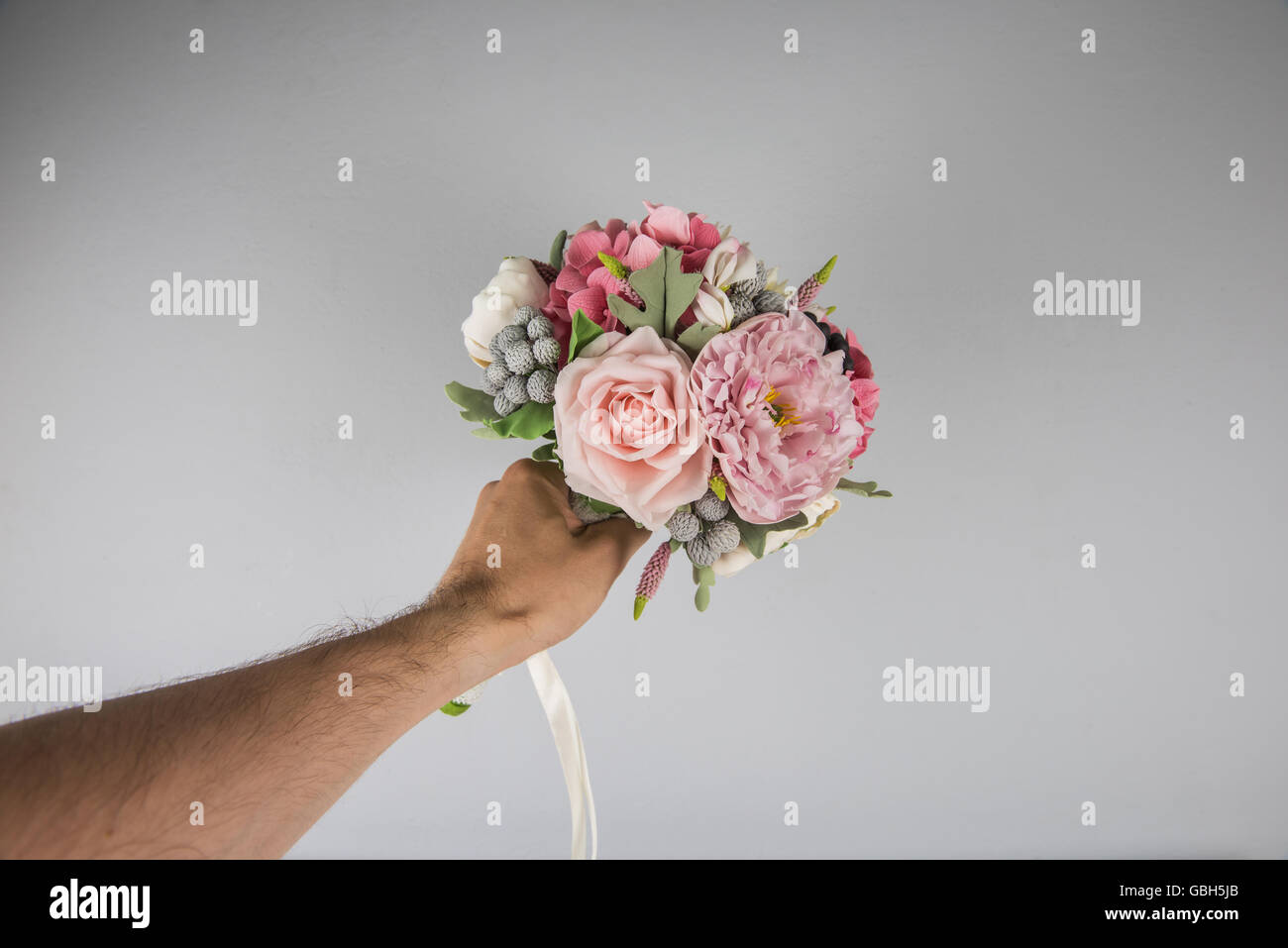 male hand giving wedding bouquet Stock Photo - Alamy