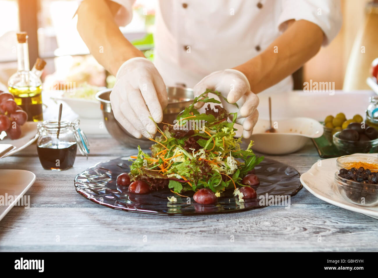 Hands of cook making salad Stock Photo - Alamy