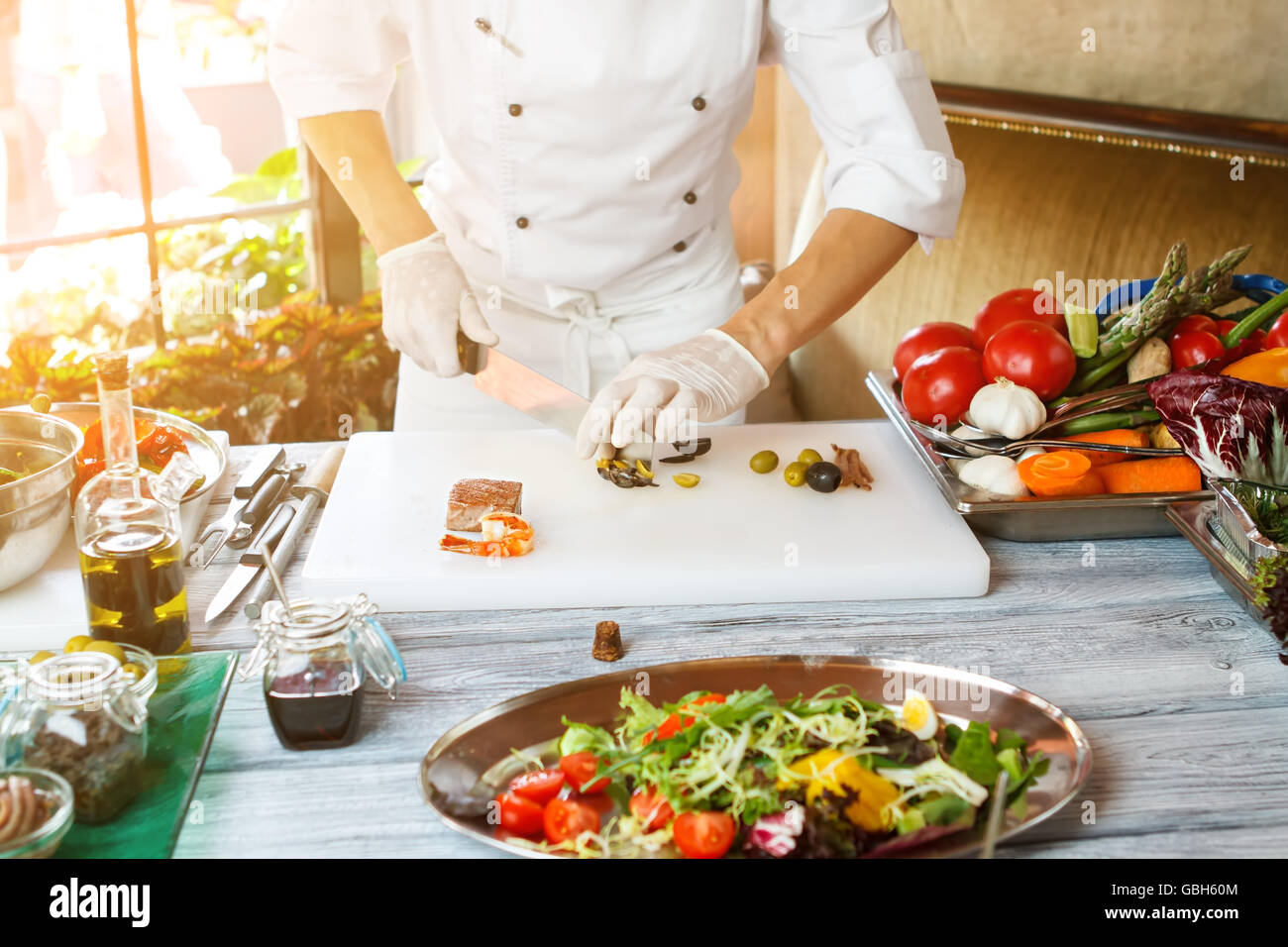 Hands with knife cut olives Stock Photo - Alamy