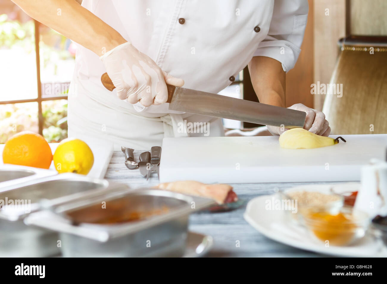 Hand with knife cutting pear Stock Photo - Alamy
