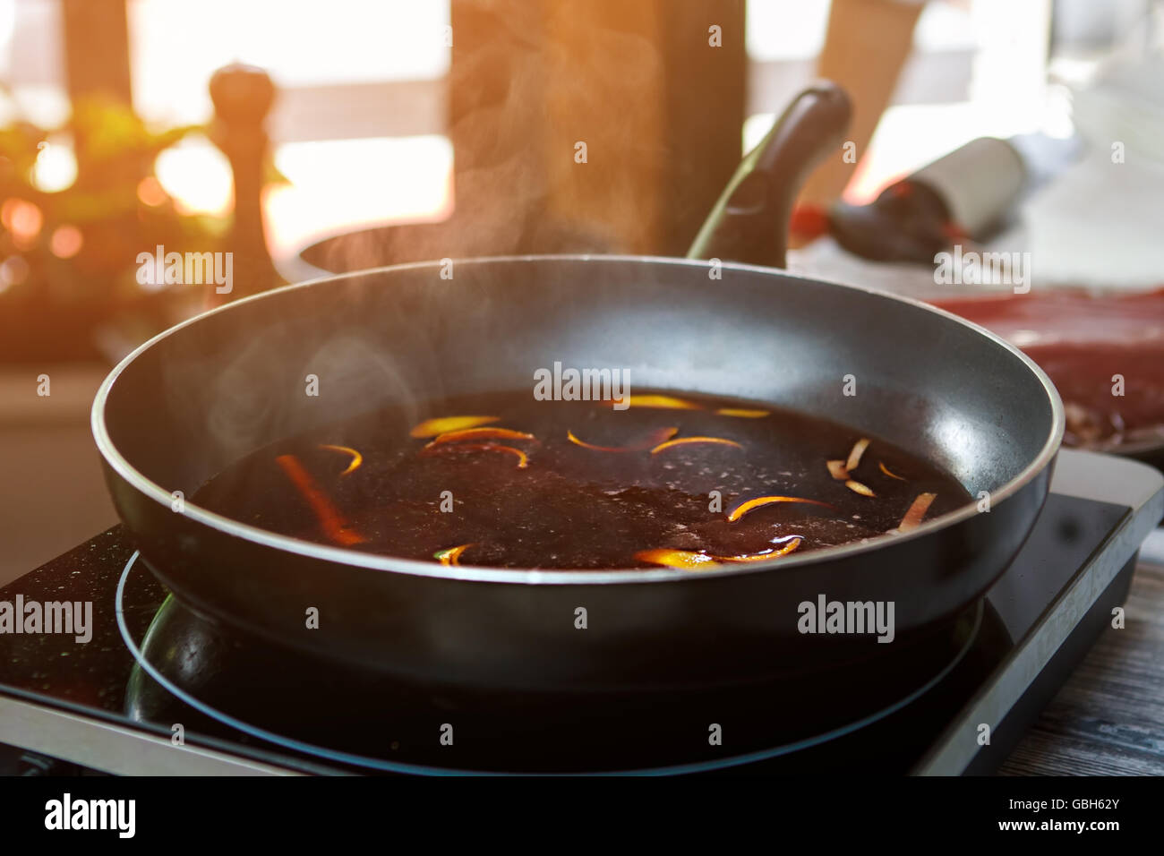 Frying pan with orange peel Stock Photo - Alamy