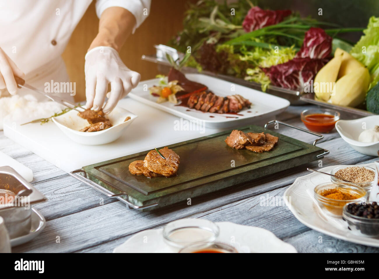 Hand holding fork with meat Stock Photo - Alamy