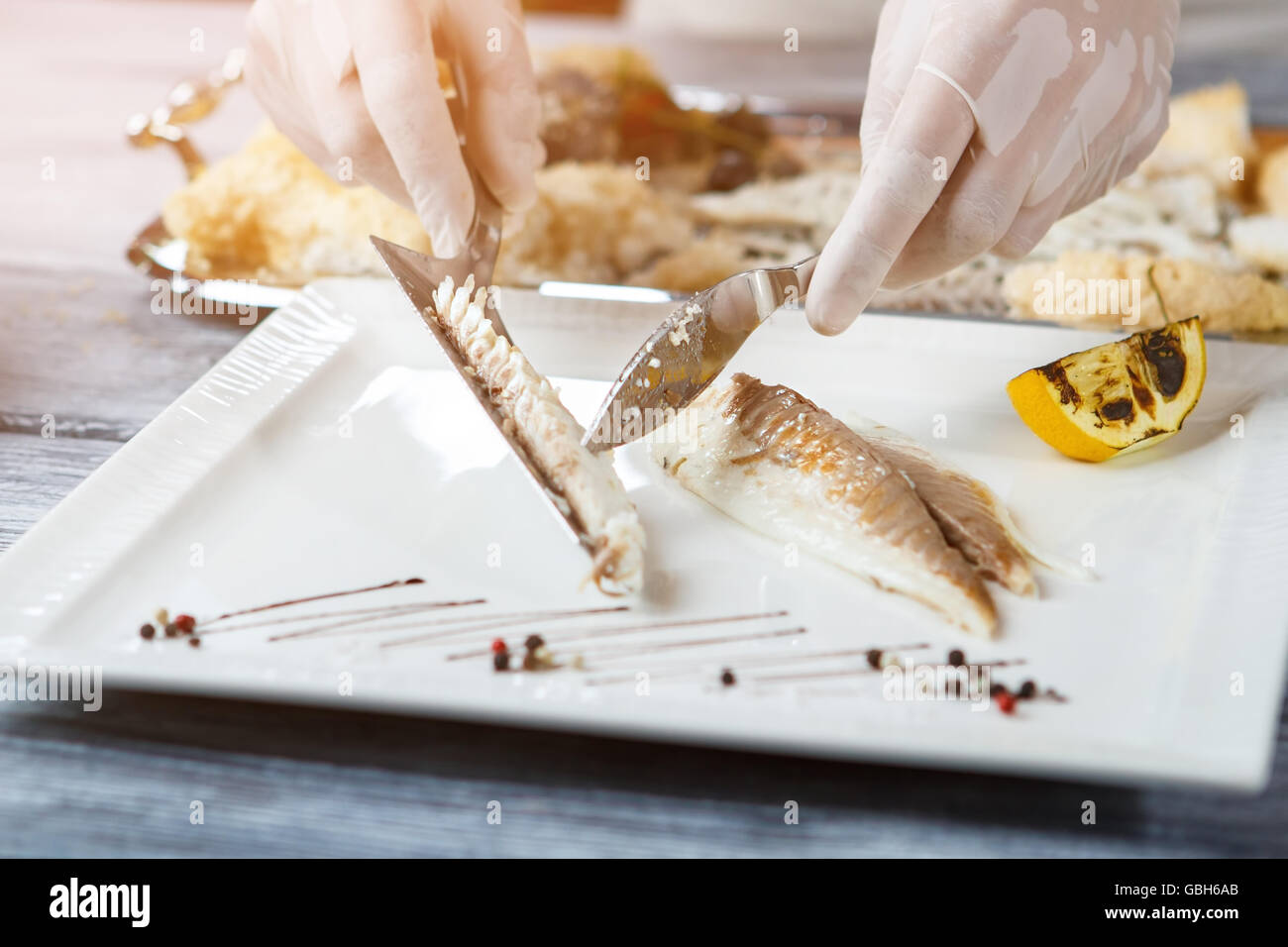 Hand holding spatula with fish Stock Photo - Alamy