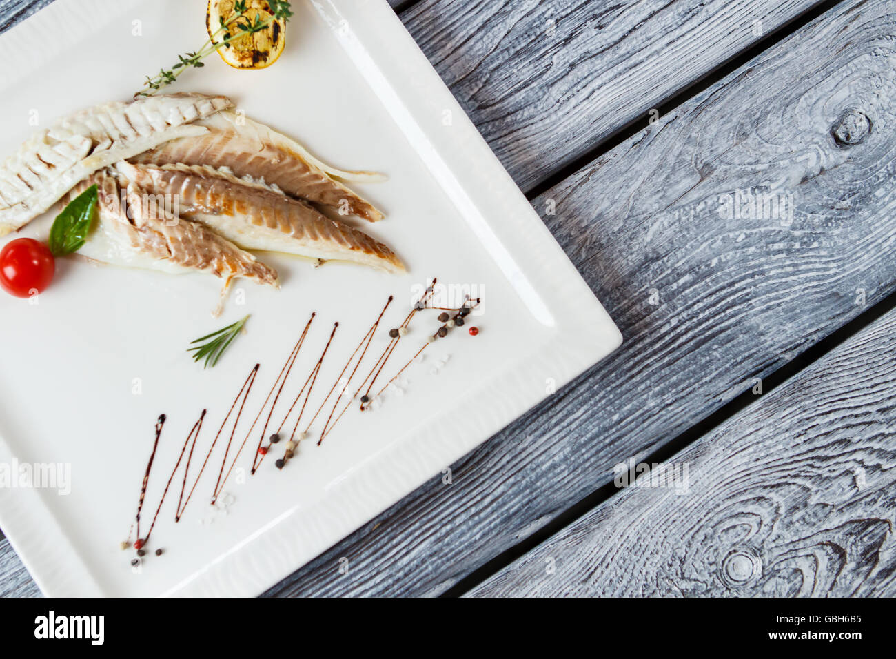 Fish fillet on white plate Stock Photo - Alamy