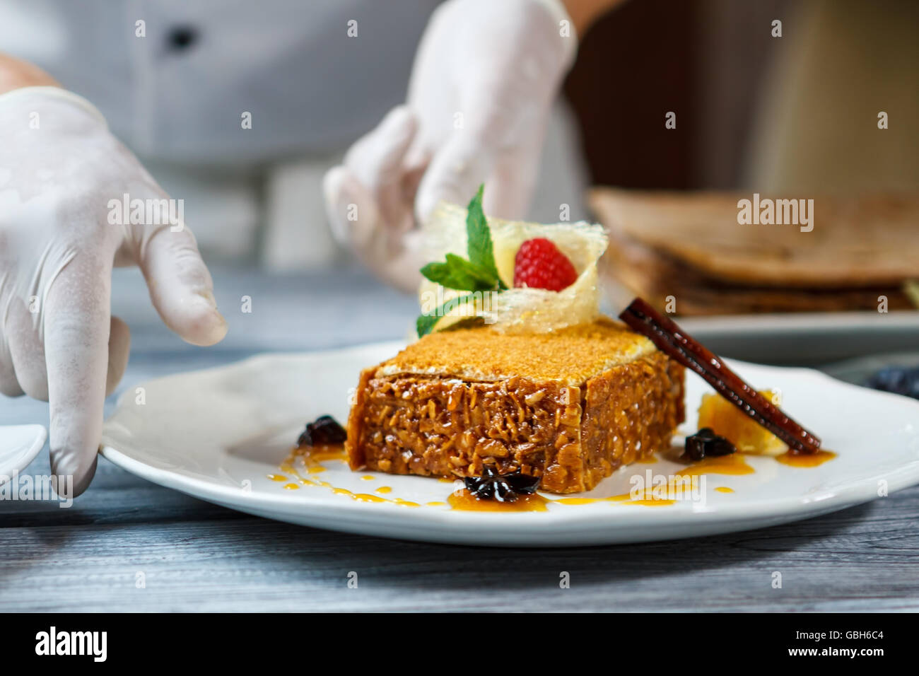 Hands touch plate with cake Stock Photo - Alamy