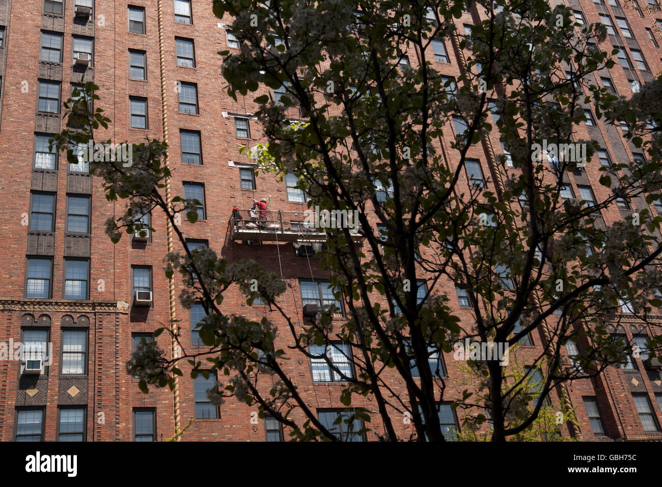 Men on a window cleaning platform hanging off the side of the London ...