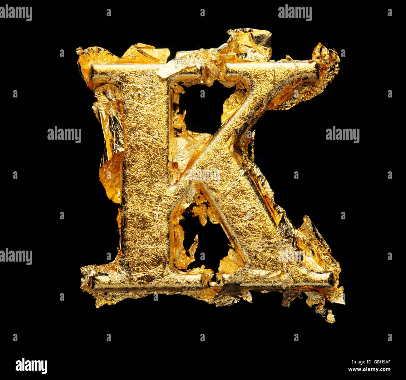 Alphabet and numbers in rough gold leaf isolated on black Stock Photo ...