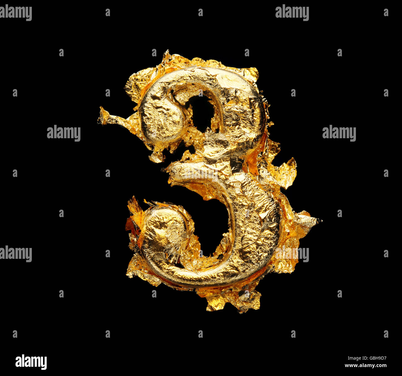 Alphabet and numbers in rough gold leaf isolated on black Stock Photo ...