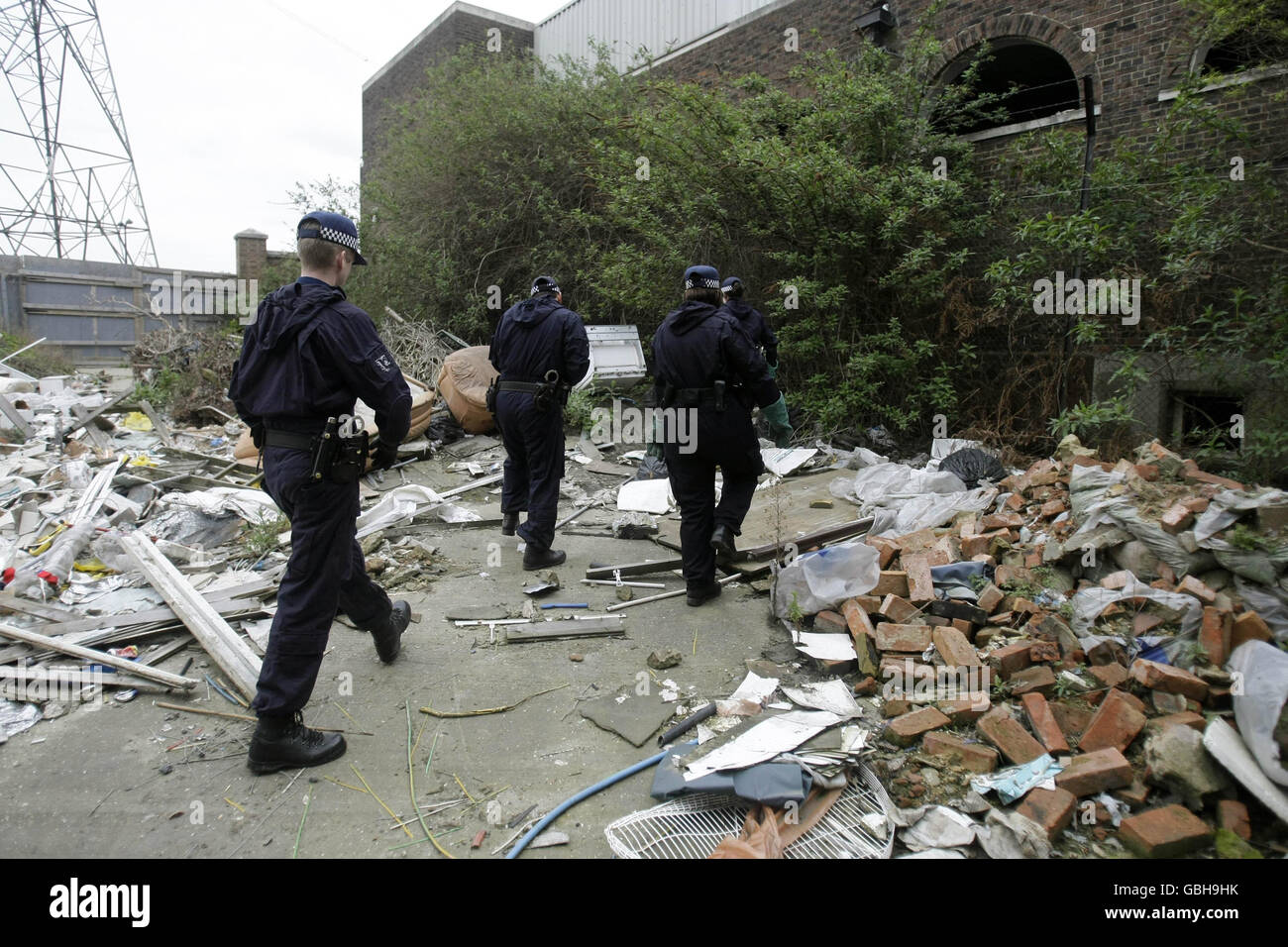 A police search team carries out checks in an unoccupied building near ...