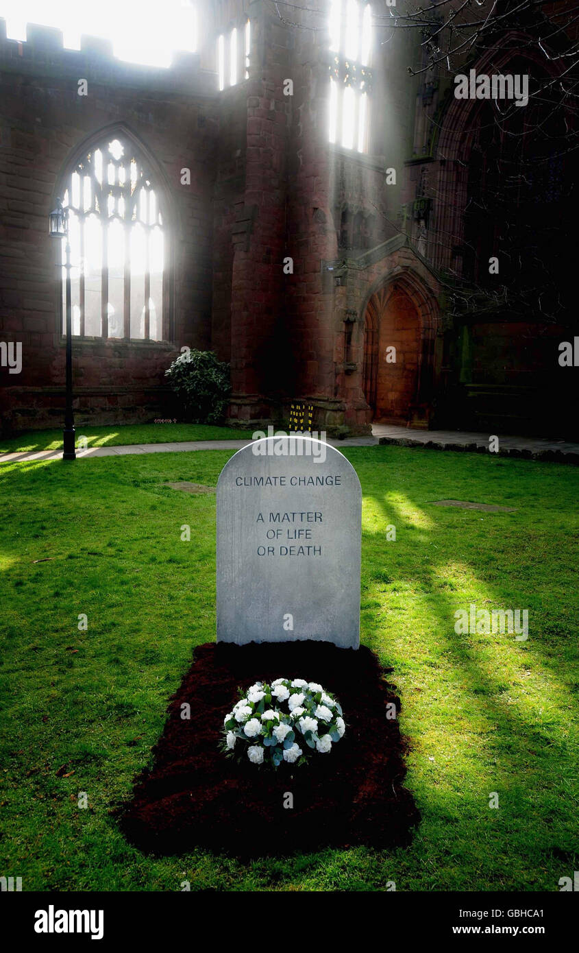 A mock grave with "Climate Change A Matter of Life or Death" engraved ...