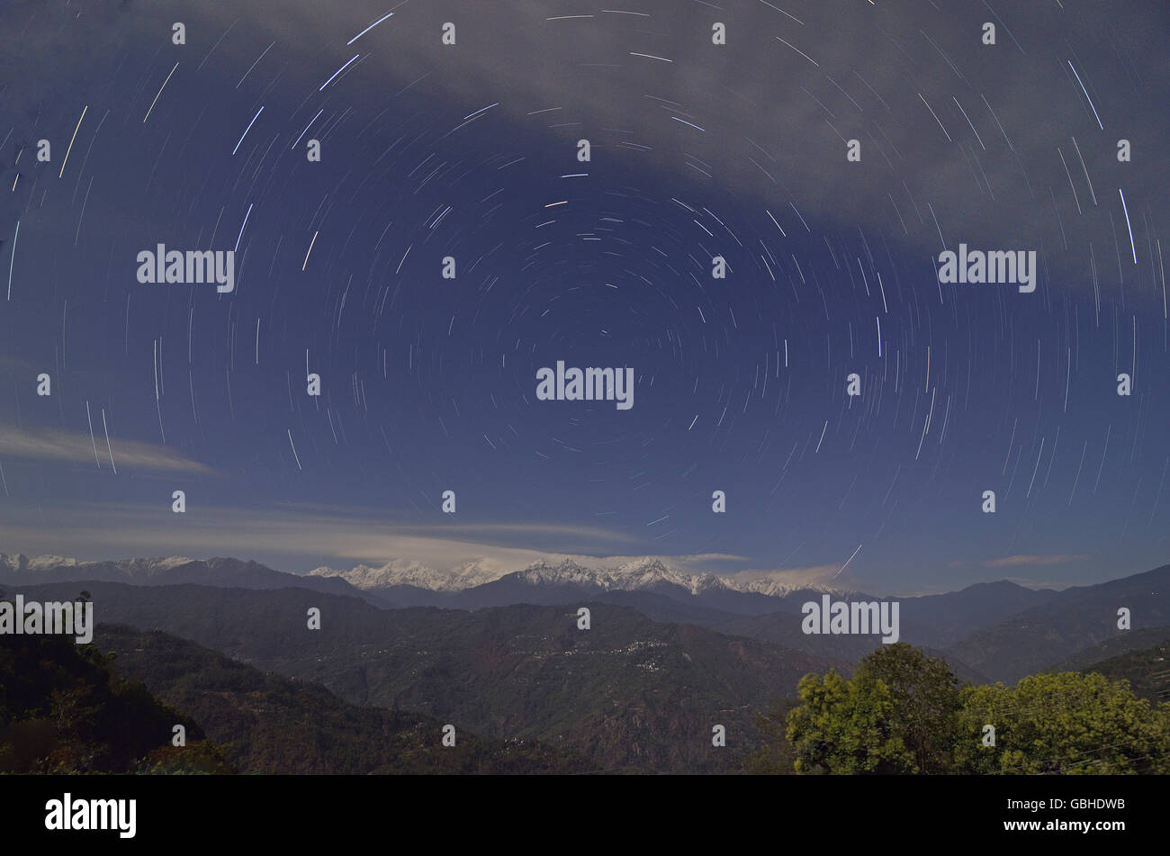 Kanchanjunga range glowing in moonlight along with star trails, Sikkim ...