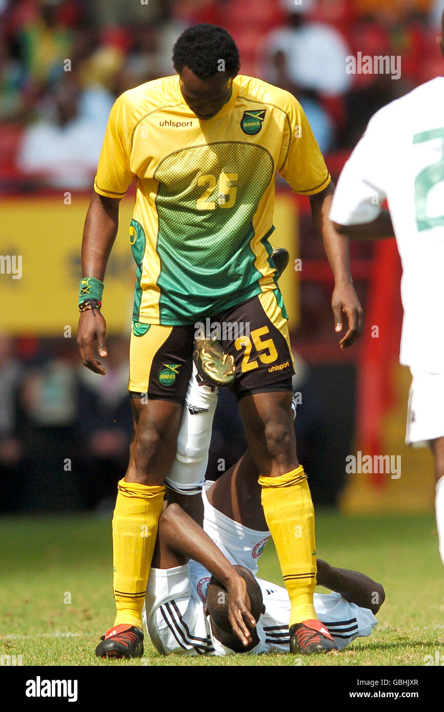 Claude Davis, Jamaica is caught in a compromising tackle Stock Photo ...