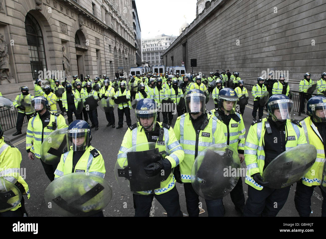 Police officers block a road during the protests outside the Bank of ...