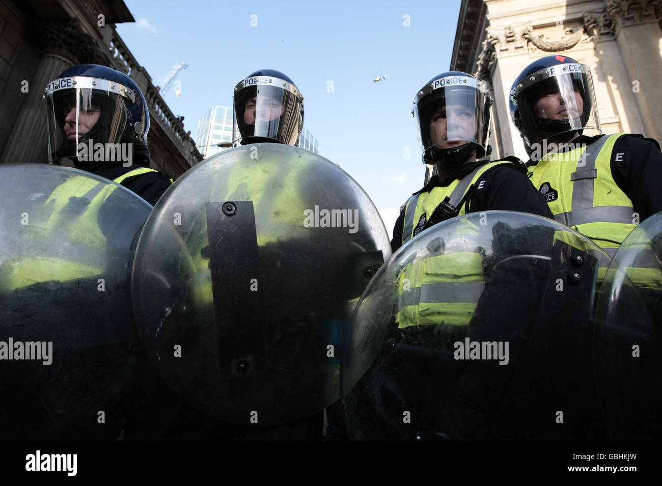 Police officers block a road during the protests outside the Bank of ...