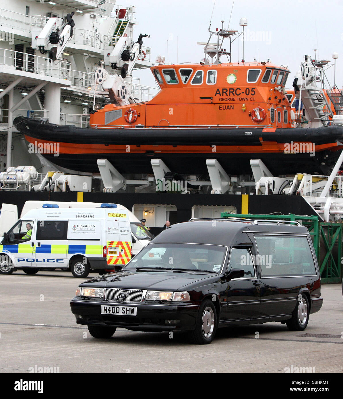 A Hearse carries the bodies of some of the men who were killed when a ...