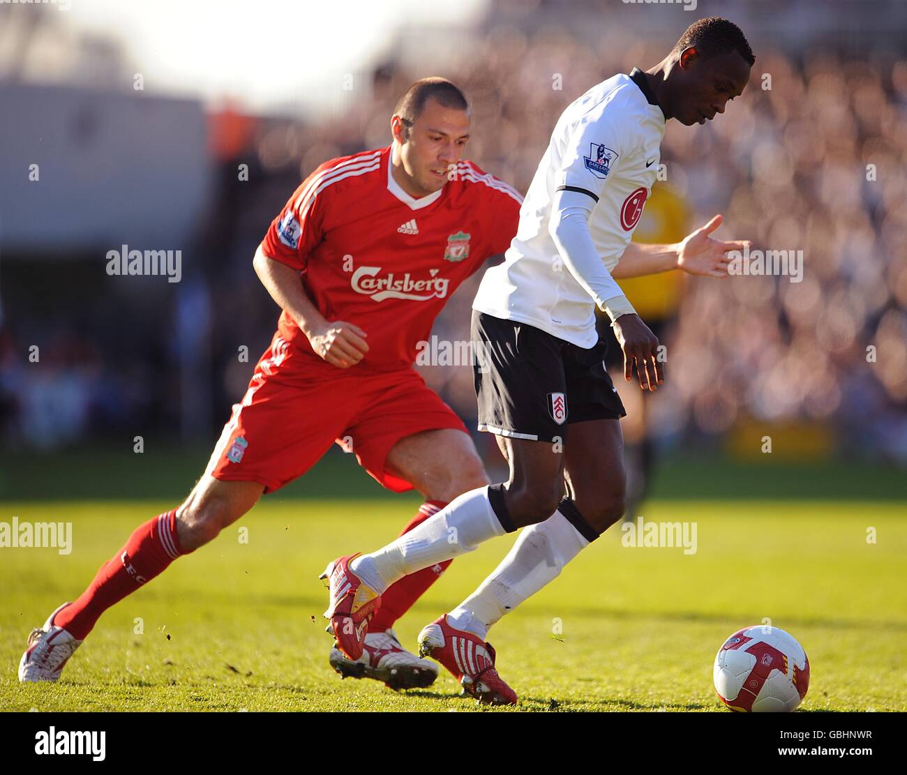 Liverpool's Andrea Dossena (left) and Fulham's John Pantsil( right ...