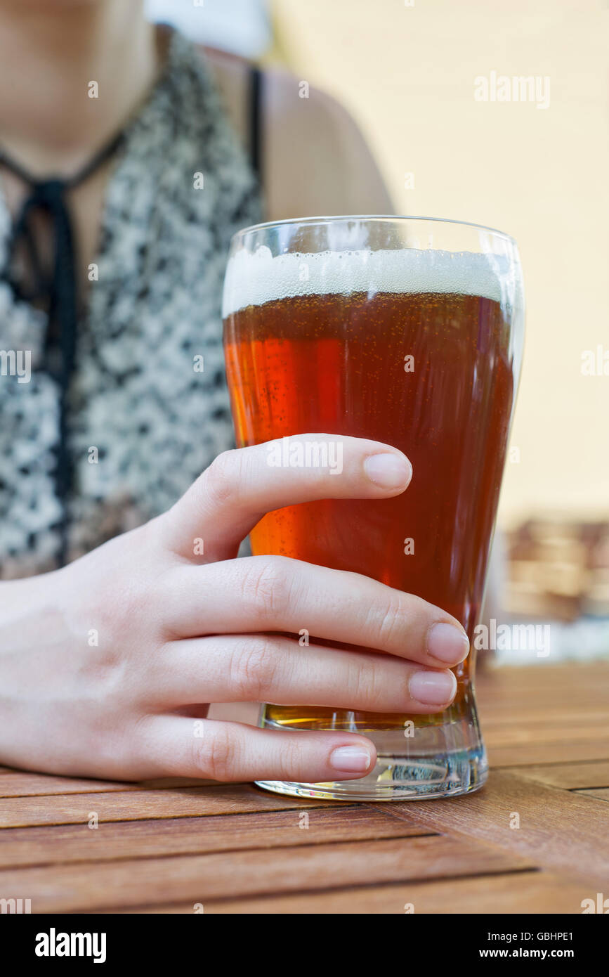 hand holding glass of beer Stock Photo - Alamy