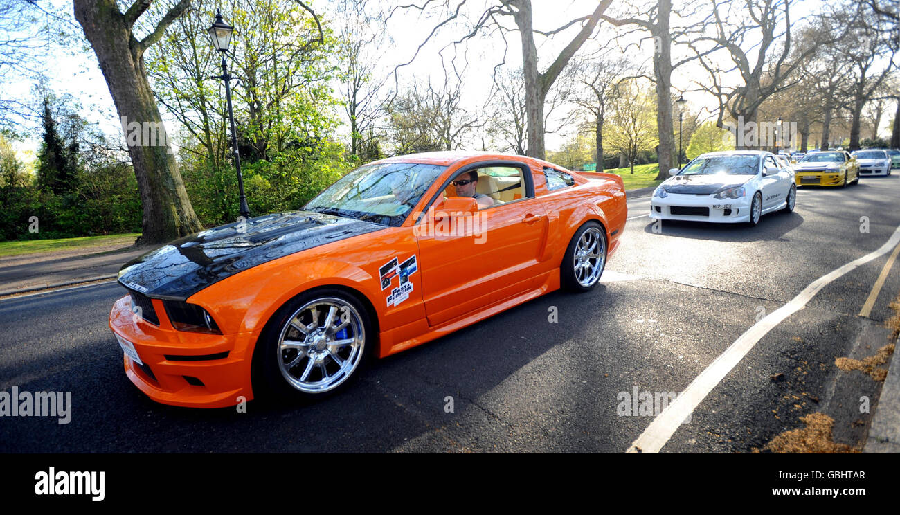 A convoy of twenty of the top UK muscle cars drive through London's ...
