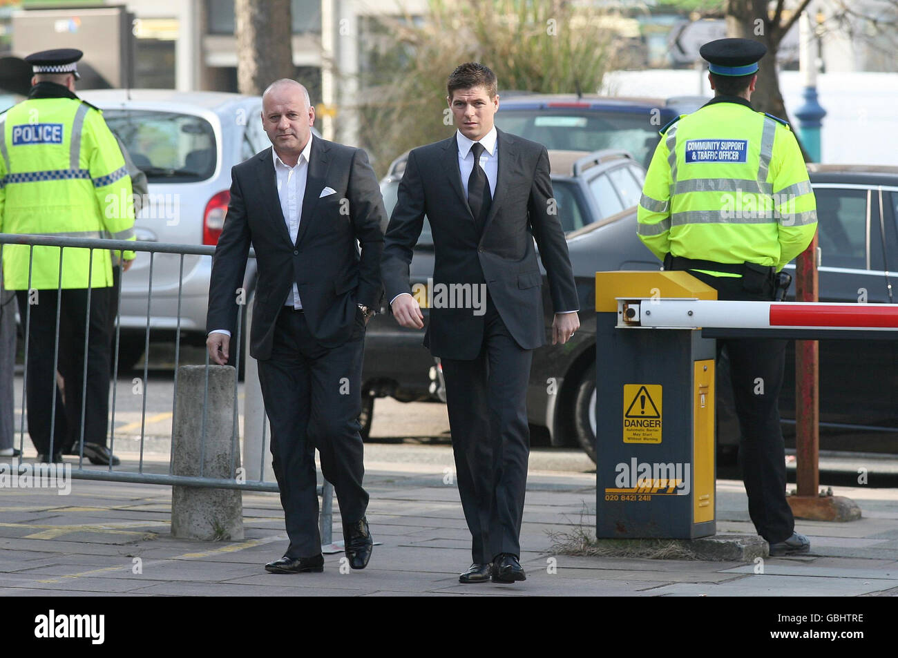Footballer Steven Gerrard (centre right) arrives with an unidentified ...