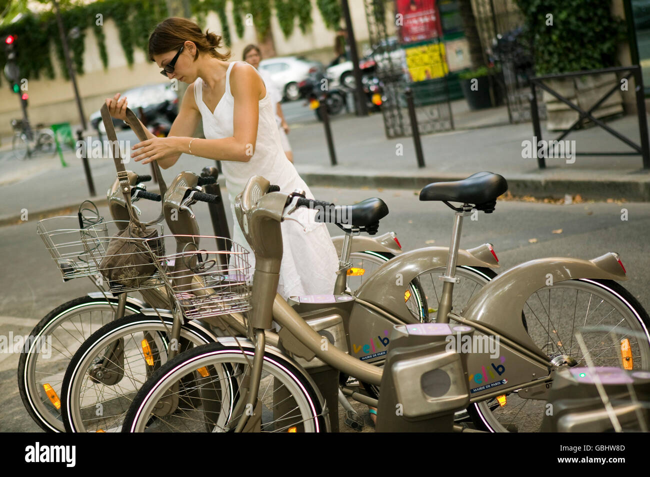 A woman returns her Velib' bicycle to a docking station in Paris ...