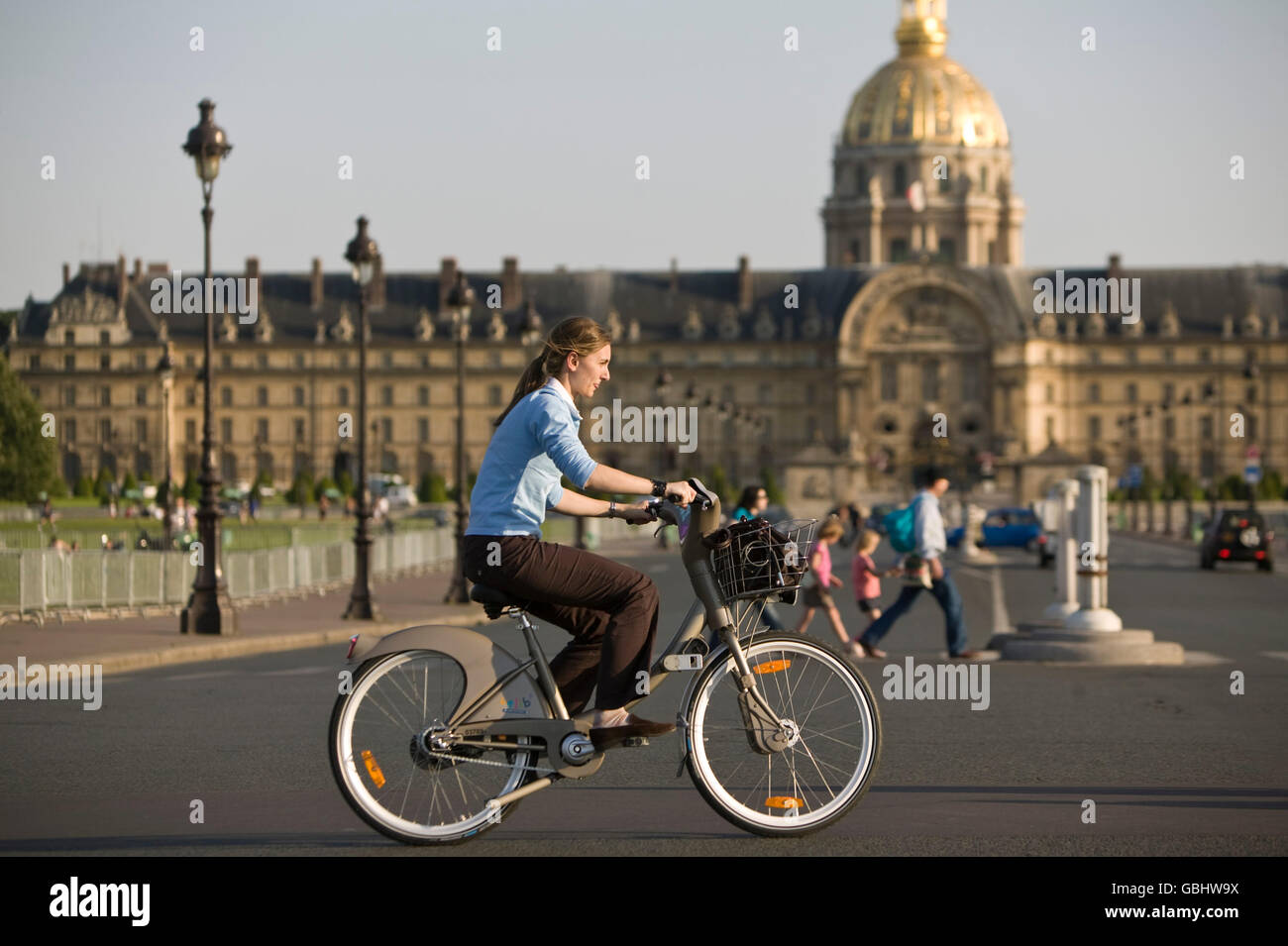 A woman rides a Velib' bicycle across the Esplanade des Invalides in ...