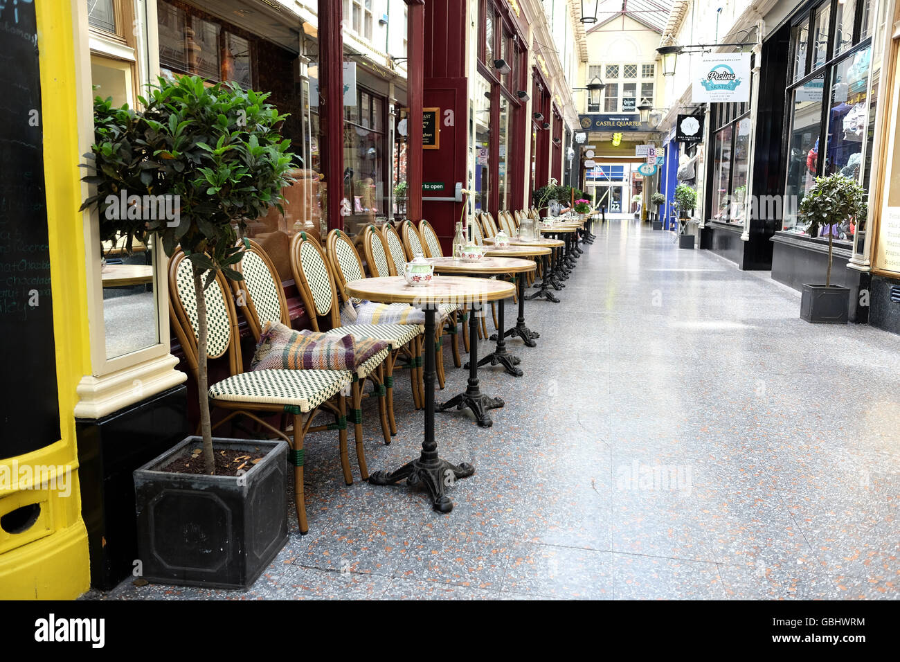 Line of café chairs in Cardiff Castle Quarter arcade July 2016 Stock ...