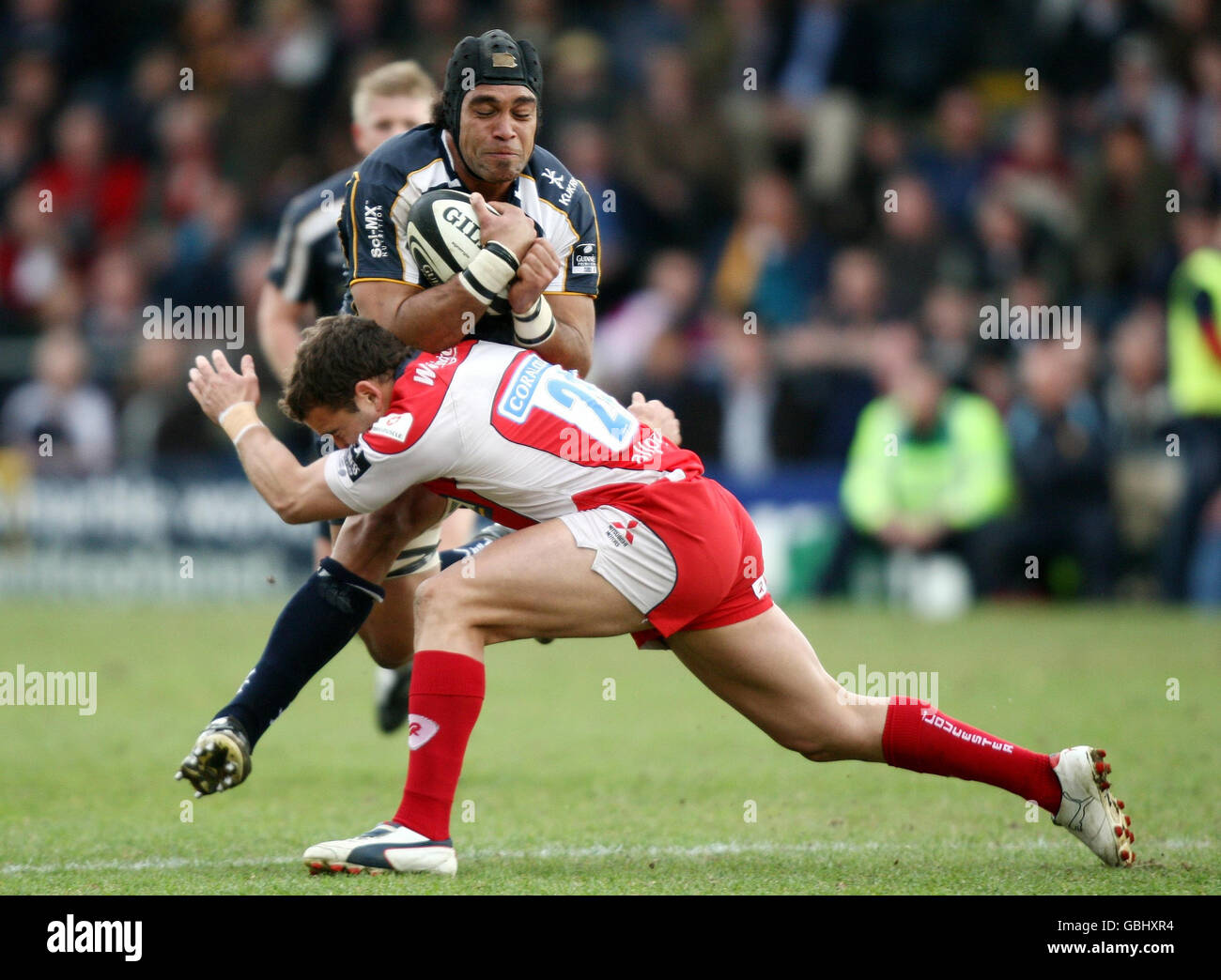 Worcester's Netani Talei is tackled by Gloucester's Olly Barkley during ...