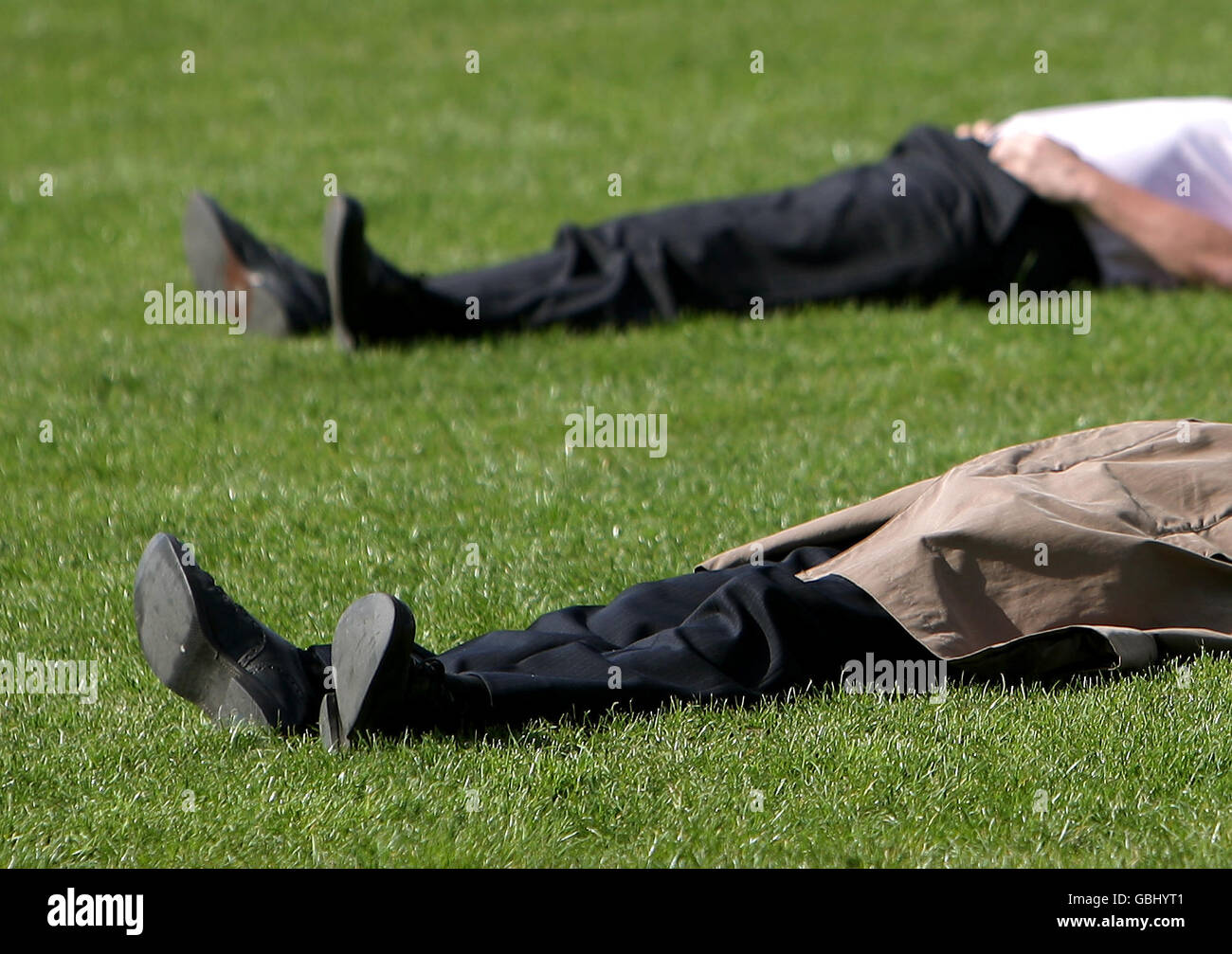 Businessmen lie in the sun in green park hi-res stock photography and ...