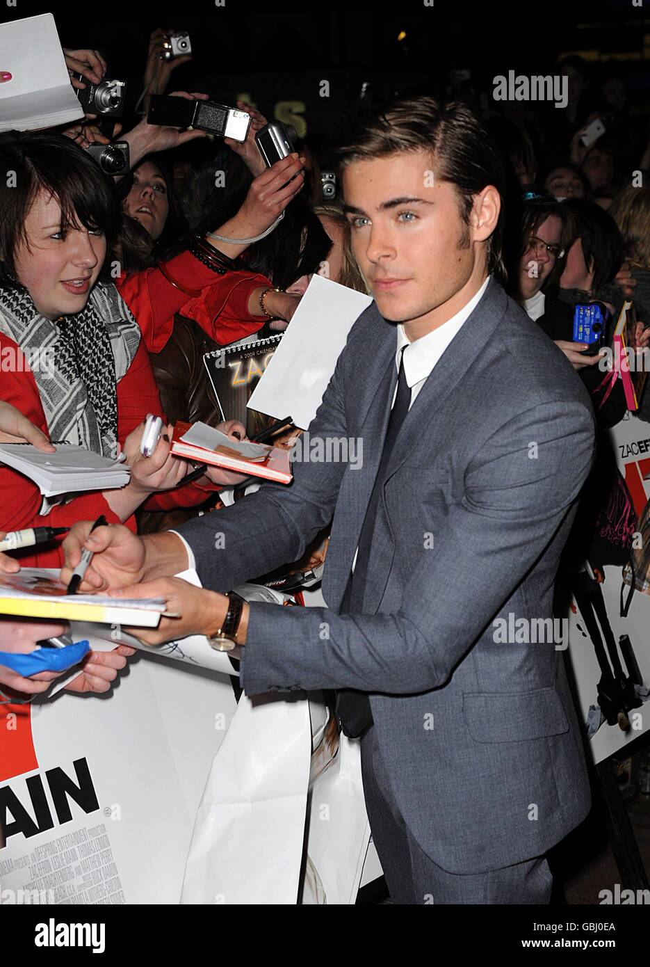 Zac Efron signs autographs for fans as he arrives for the UK Premiere ...