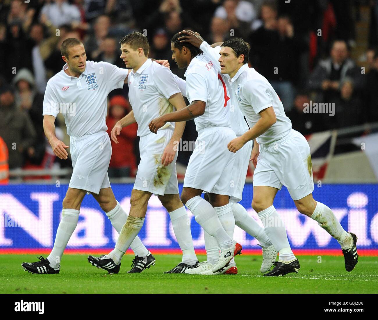 England's Steven Gerrard (2nd left) is congratulted by team mates ...