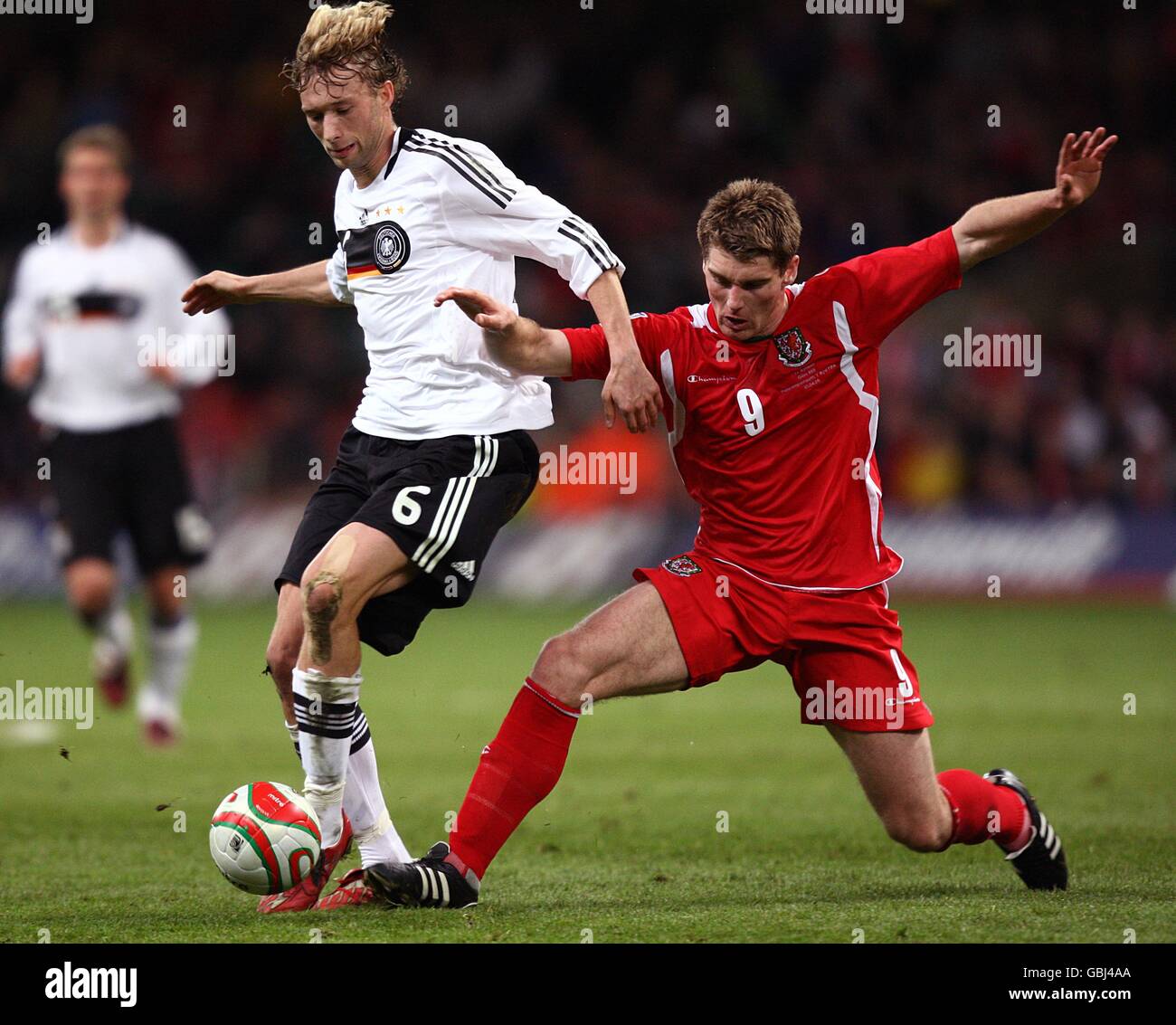 Germany's Simon Rolfes (left) and Wales' Sam Vokes (right) battle for ...
