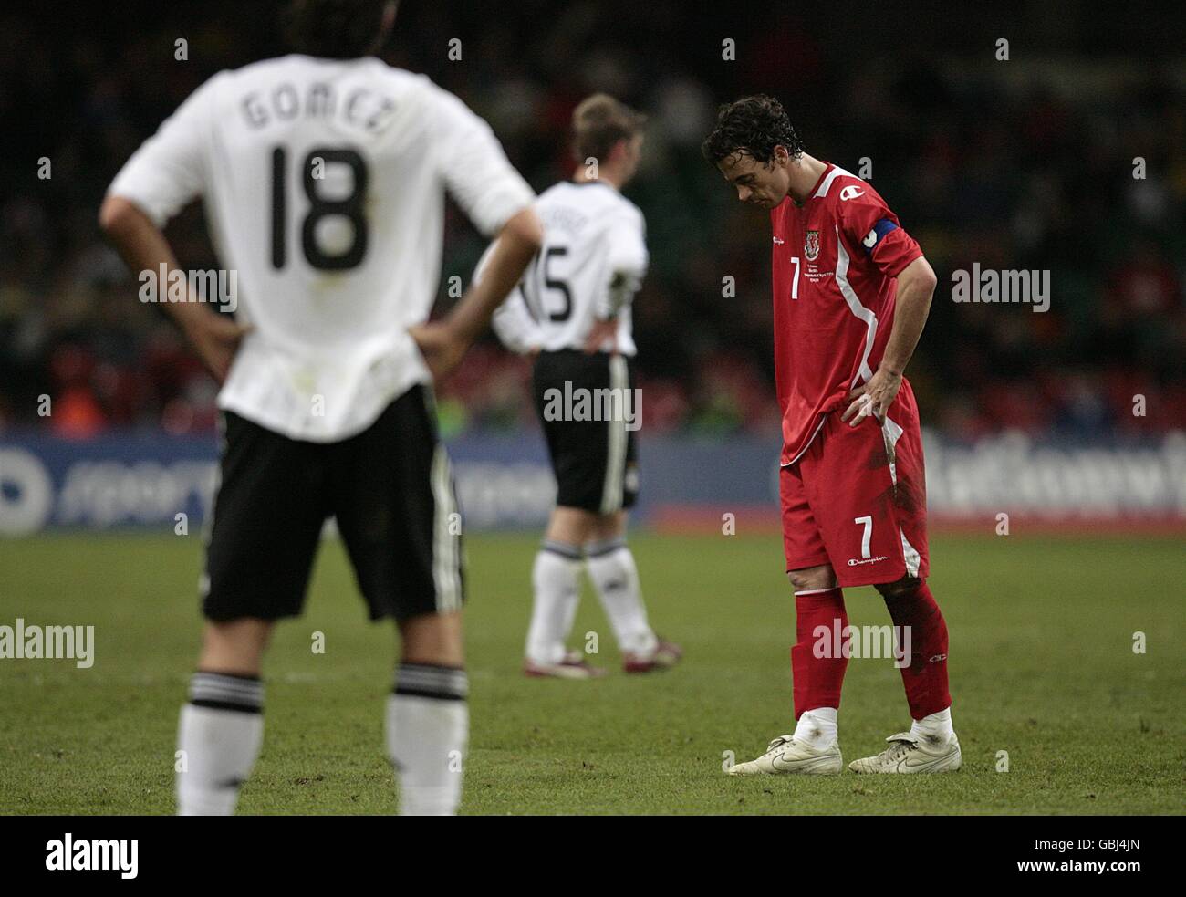 Wales captain Simon Davies (right) looks down at the ground dejected ...