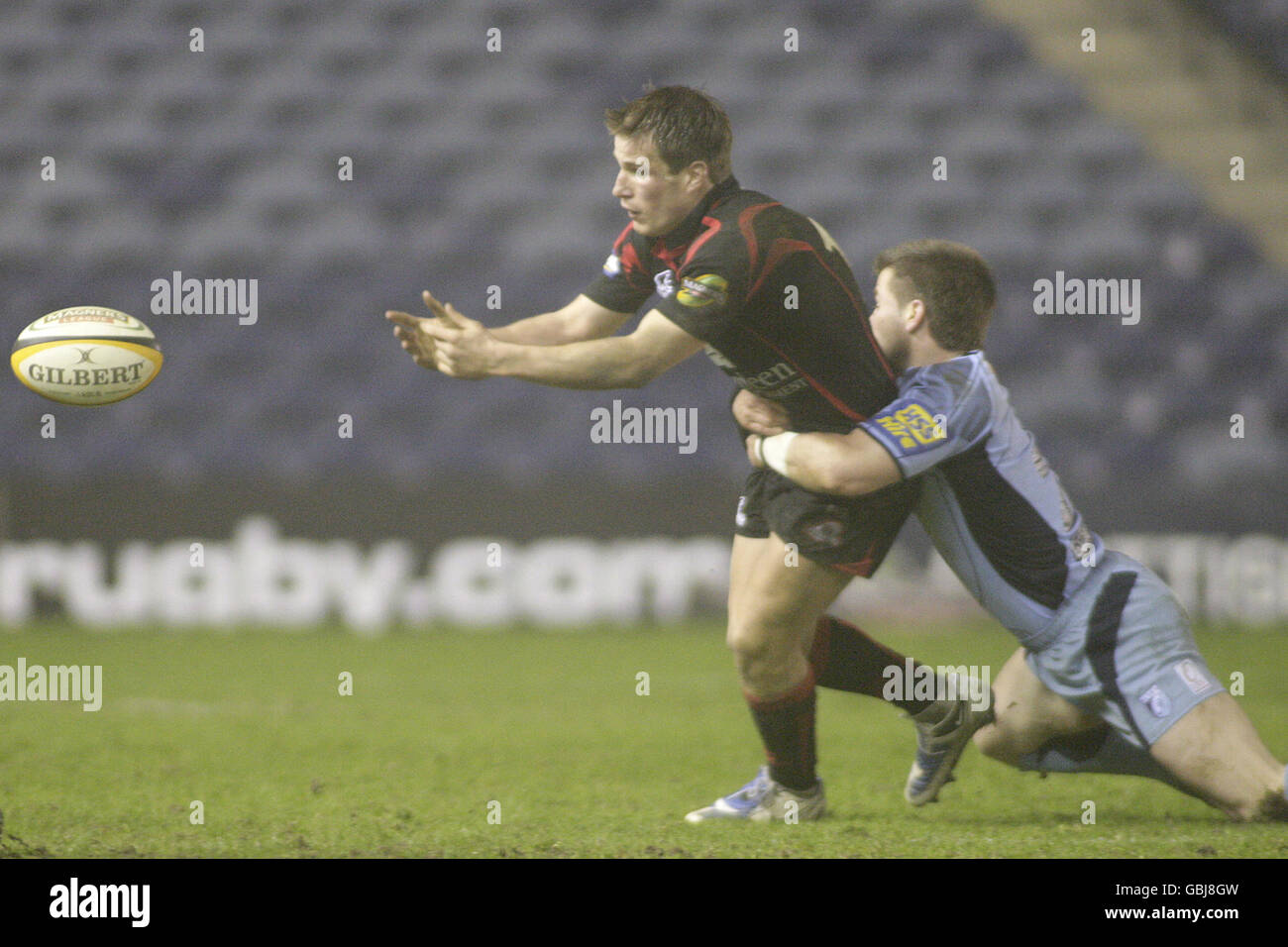 Edinburgh's Phil Godman offloads the ball under pressure From Cardiff ...