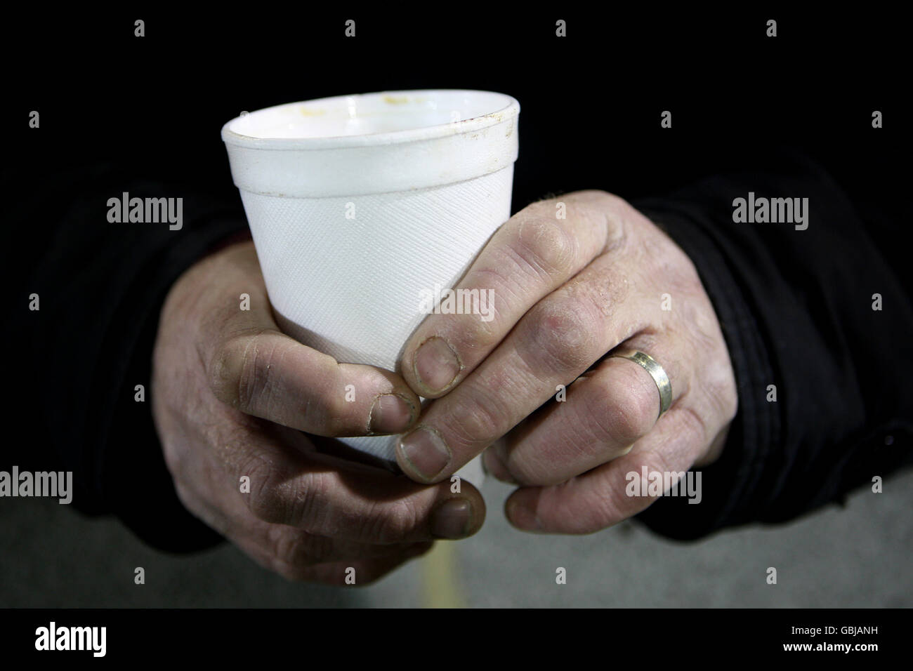 A spectator watches the game with a cup of tea from the stands at The ...