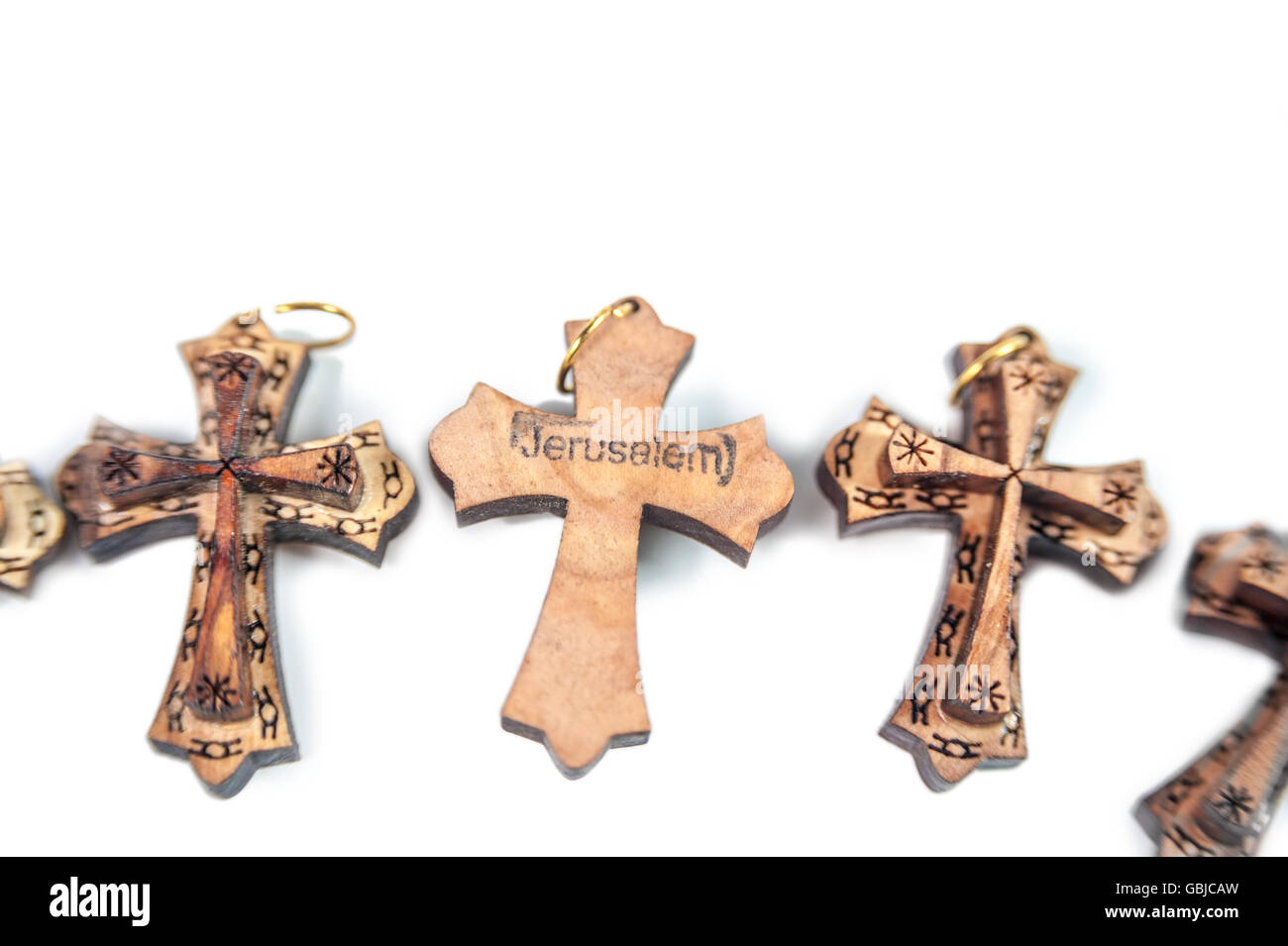 Row of wooden crosses isolated on white background Stock Photo - Alamy