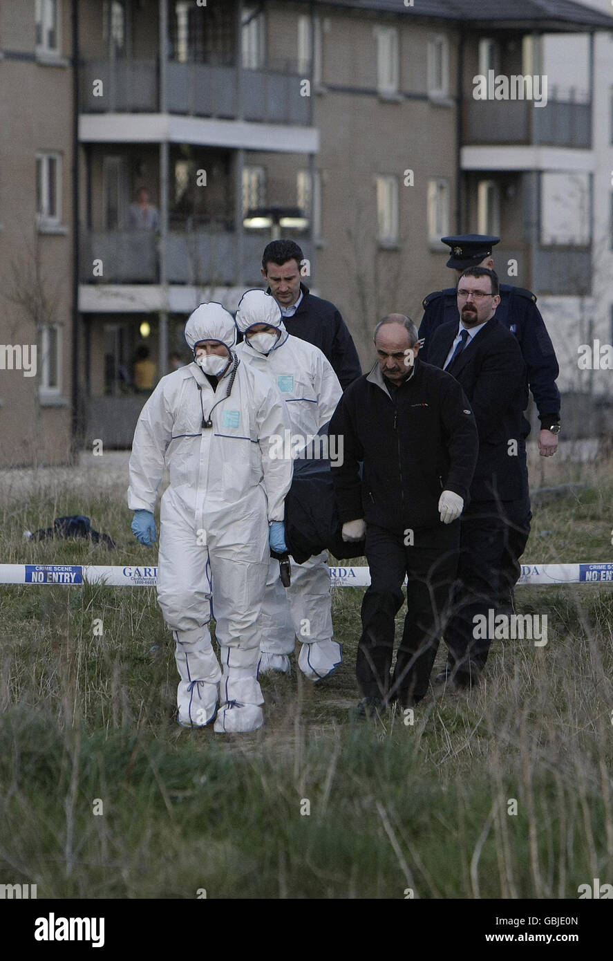 Crime scene investigators remove the body of a man believed to be in ...