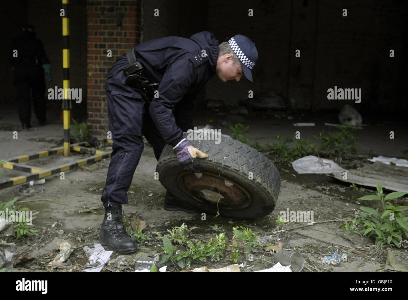 A police search team carries out checks in an unoccupied building near ...