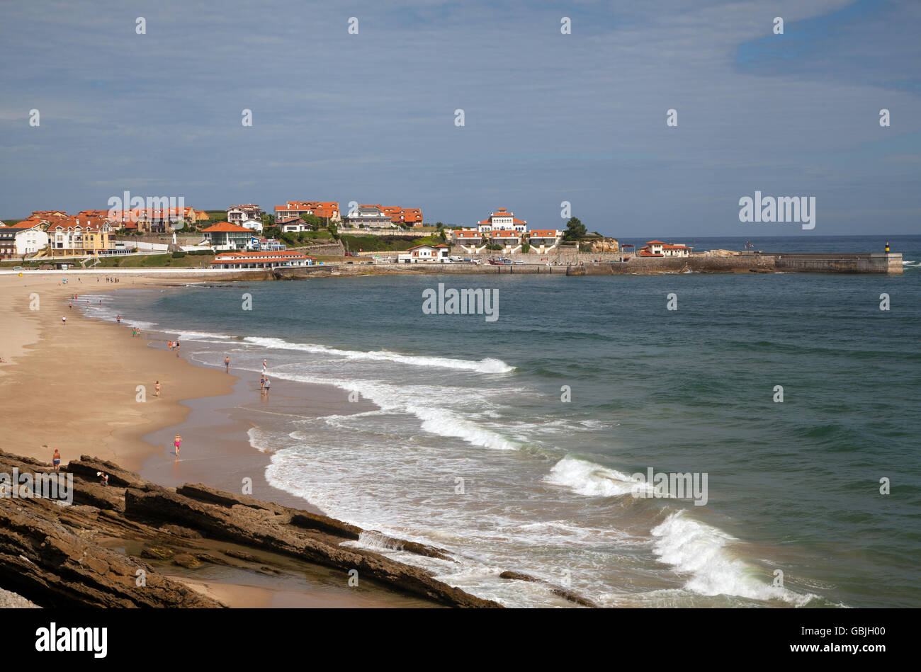 View of the beach and harbour at the seaside resort of comillas ...