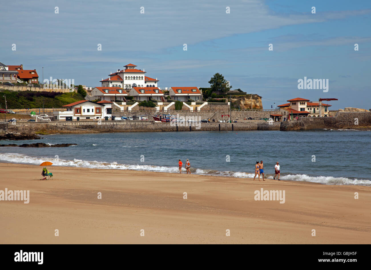 View of the beach and harbour at the seaside resort of comillas ...