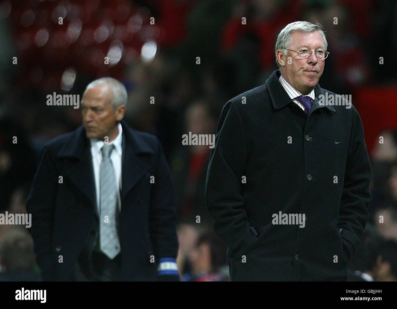 Manchester United's manager Alex Ferguson (right) walks off the pitch ...